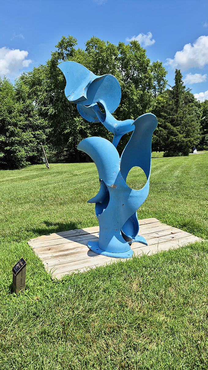 This blue sculpture twists skyward like frozen jazz, its curves and openings creating a different composition from every angle you approach.