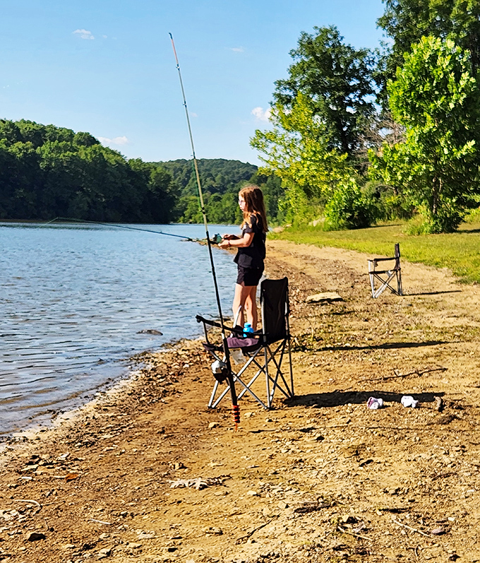 Patience personified: A young angler demonstrates the timeless art of fishing&mdash;equal parts skill, hope, and comfortable folding chairs.