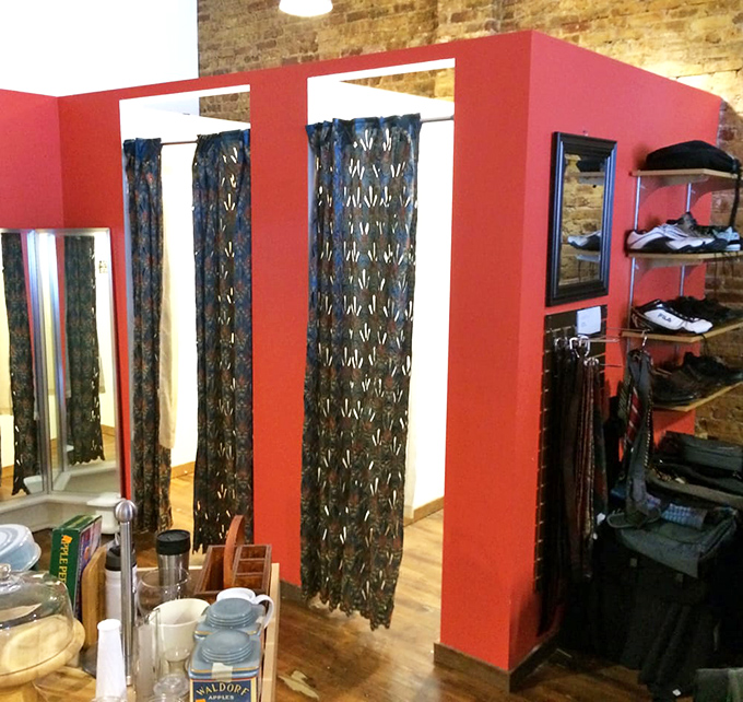 Fitting rooms with personality! These vibrant red changing areas make trying on your potential treasures feel like a boutique experience.
