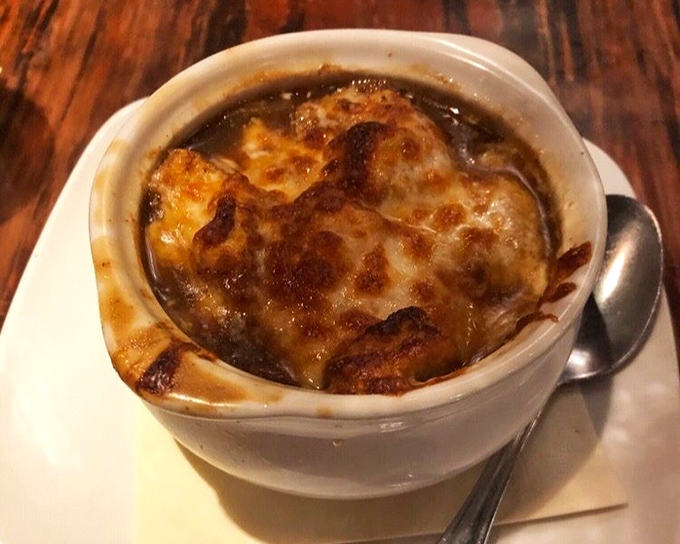 French onion soup with a golden crown of melted cheese &ndash; comfort food that's worth the inevitable chin dribble.
