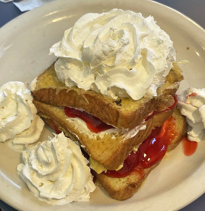 French toast that doesn't need a passport to impress, topped with enough whipped cream to make a cloud jealous.
