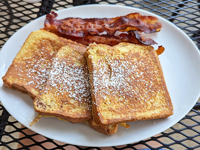 French toast dusted with powdered sugar and paired with bacon &ndash; breakfast's perfect sweet-and-savory romance story on a plate.