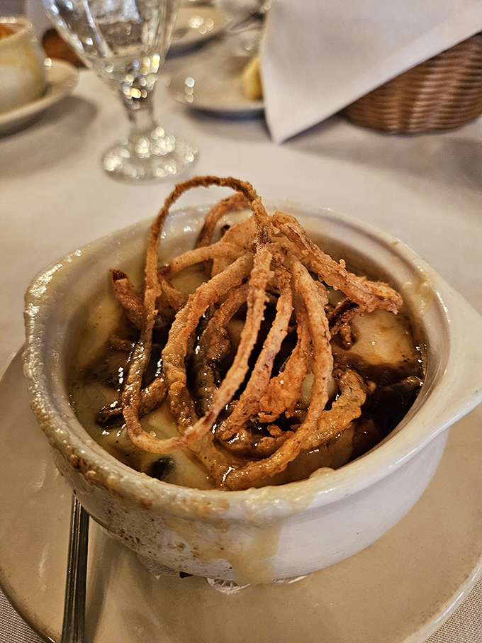 French onion soup with a crown of crispy onions&mdash;because sometimes cheese needs to wear a crunchy hat to the party.