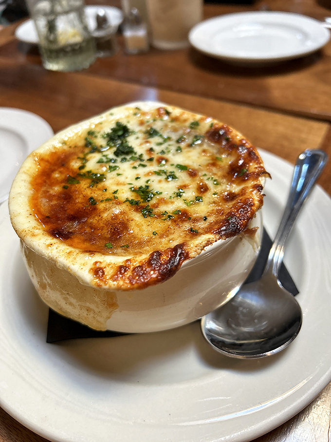 French onion soup with a cheese cap so perfectly browned, it deserves its own standing ovation. That pull-apart moment is pure culinary theater.