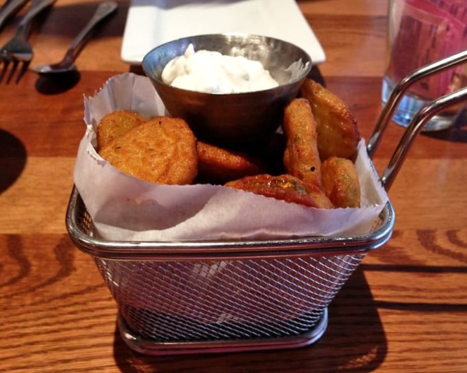 Fried pickles arrive hot, crispy, and ready for their cool dip in creamy sauce &ndash; the perfect opening act before the burger main event.