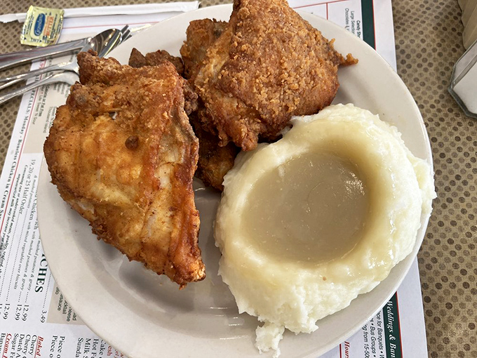Fried chicken with a crust so perfectly golden and crisp, it makes a satisfying sound when your fork breaks through to the juicy meat beneath.