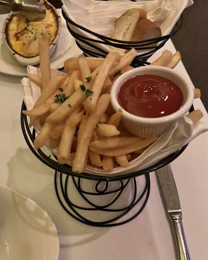 Fries served in that spiral metal basket that somehow makes them taste better. The ketchup is just a formality.