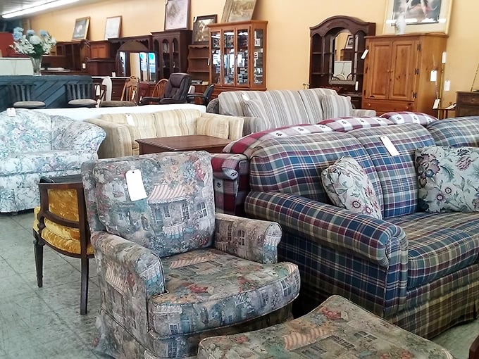 Furniture showroom filled with plaid armchairs and wooden cabinets straight from your grandmother's best parlor.