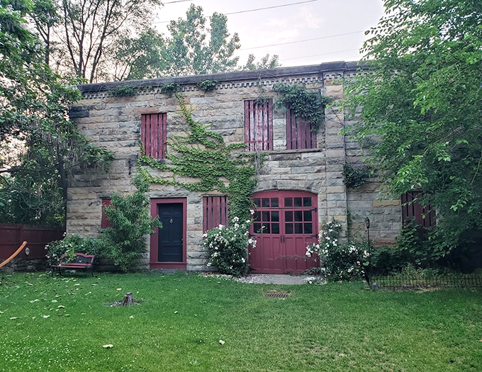 White roses bloom against stone walls, nature's innocent counterpoint to the building's reputation for things that go bump in the night.