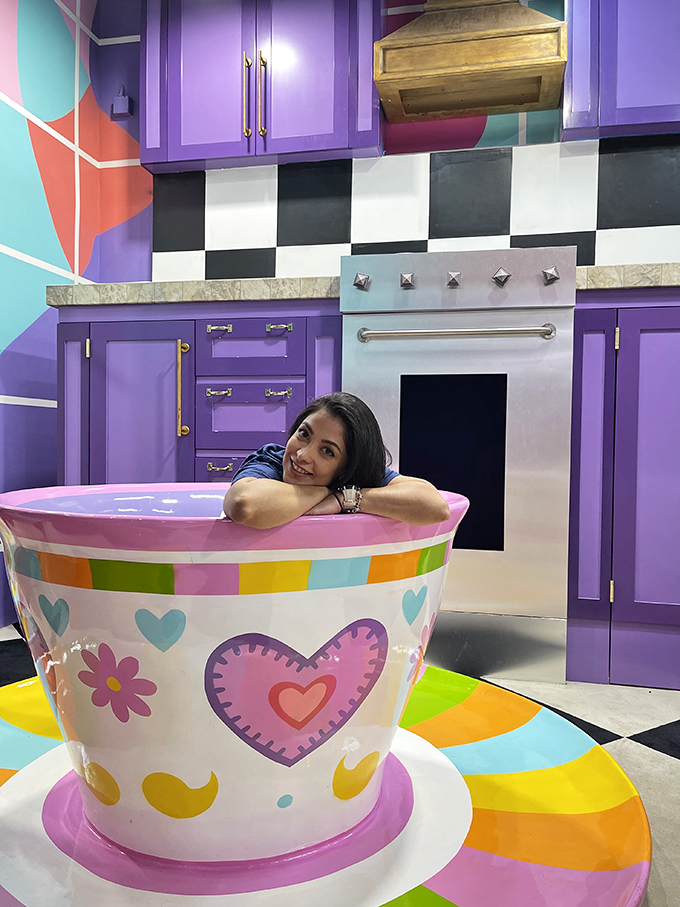 Alice would feel right at home in this oversized purple kitchen where teacups could double as bathtubs.