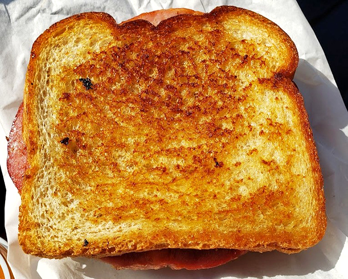 The perfectly golden grilled cheese&mdash;butter-kissed bread embracing melted American cheese&mdash;proves that three simple ingredients can create something greater than their sum.