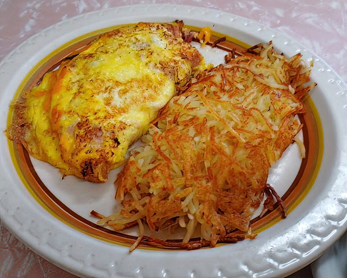 An omelet that's achieved that elusive perfect fold, alongside hash browns with the ideal crisp-to-tender ratio that most home cooks can only dream about.