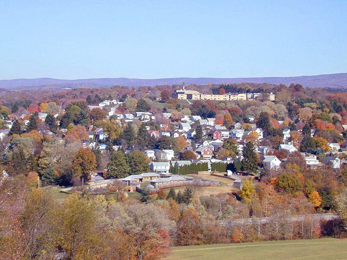 Hilltop views reveal a town nestled perfectly in Pennsylvania's embrace, untouched by urban sprawl.