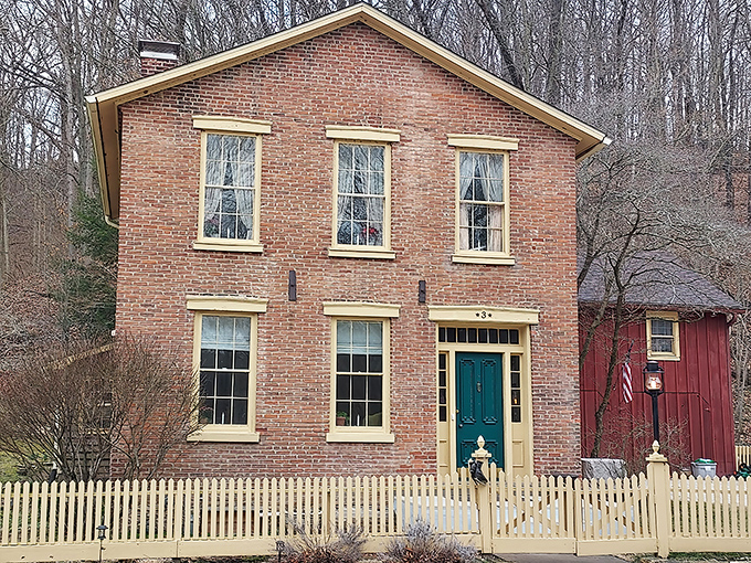 Behind this pristine white picket fence sits a brick Federal-style home that's weathered nearly two centuries with more grace than most of us manage in a day.