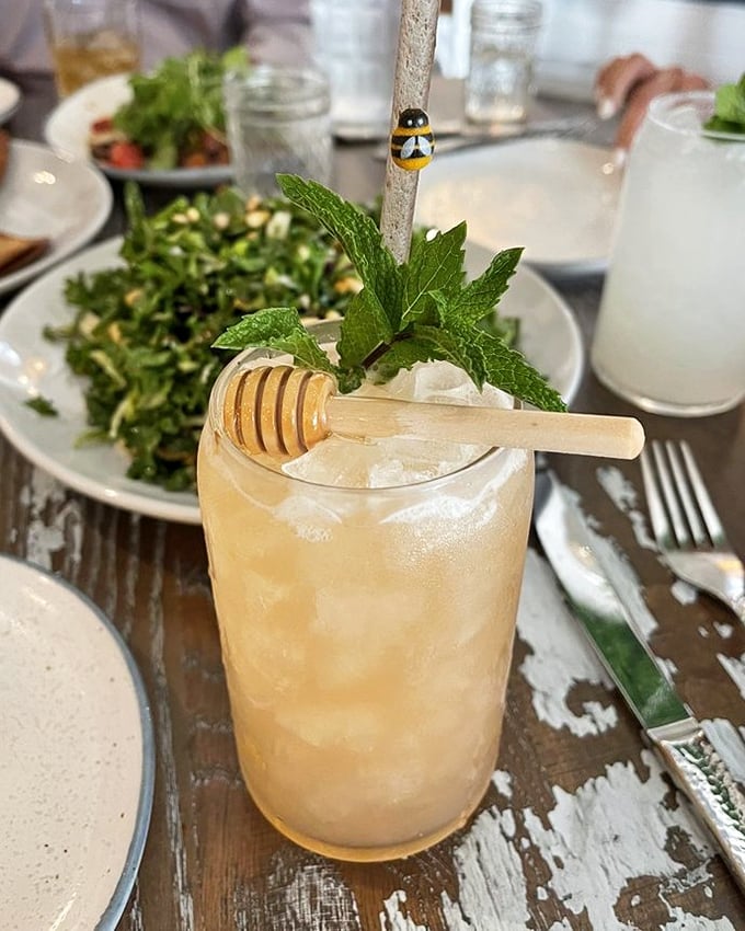 This honey-infused cocktail, garnished with fresh mint and a honey dipper, isn't just a drink&mdash;it's liquid sunshine in a glass.