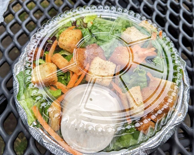 The to-go salad: nature's way of helping you pretend you're making healthy choices while carrying out a pizza that's pure indulgence.
