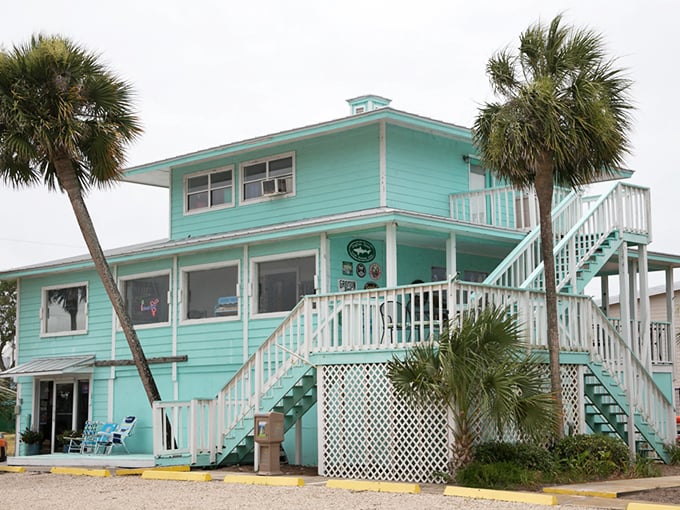 This aqua-hued beach house embodies island living with its weathered charm, multiple decks, and promise of endless summer days.