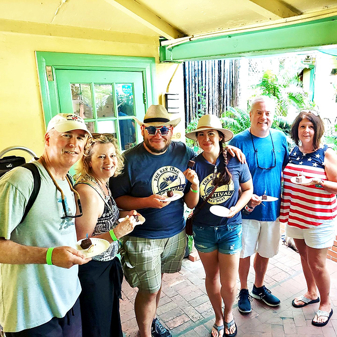 A group of festival-goers celebrating the fruit that made Key West famous. Their smiles say it all: life is sweet when there's pie.