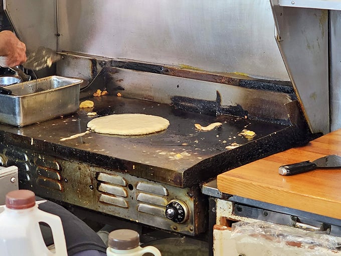 The well-seasoned flat-top grill holds decades of flavor memories, with each pancake inheriting a hint of everything that came before it.