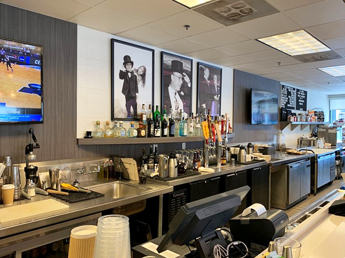 The bar area balances efficiency with elegance, where classic cocktails complement classic sandwiches. Those black and white photos tell stories of celebrations past.