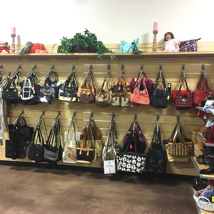 Handbag heaven! Designer lookalikes and genuine finds hang in suspended animation, waiting for their next shoulder to ride.