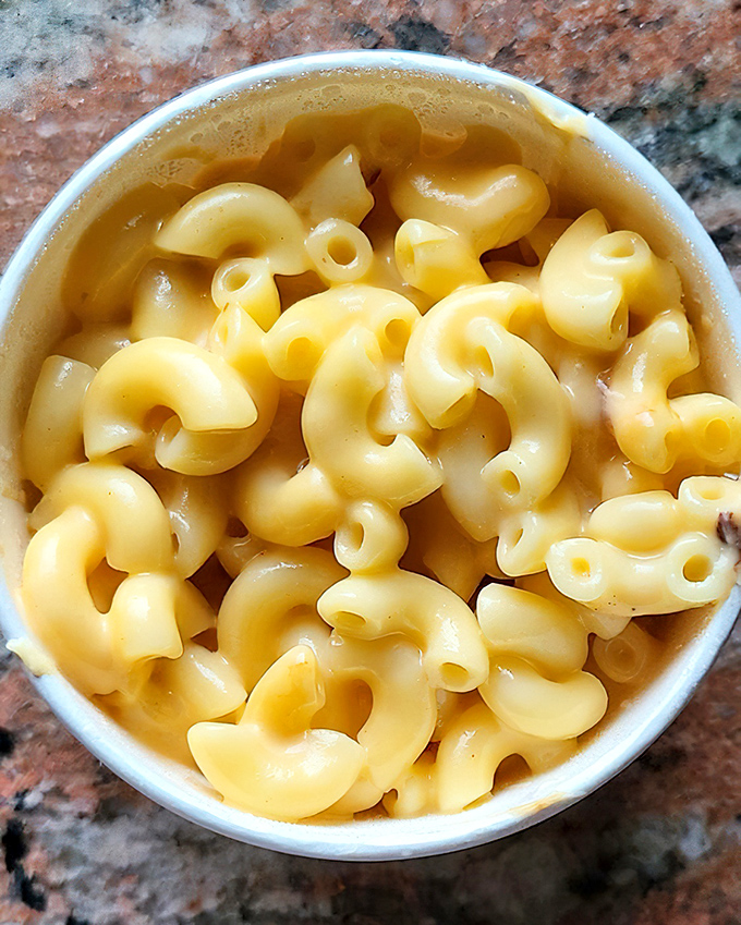 Mac and cheese so creamy and golden it should be classified as a precious metal – each spiral pasta perfectly coated in cheese that pulls with every forkful.