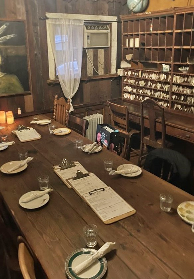 The dining room's vintage mail sorter and wooden table create an atmosphere where time slows down and meals become memories.