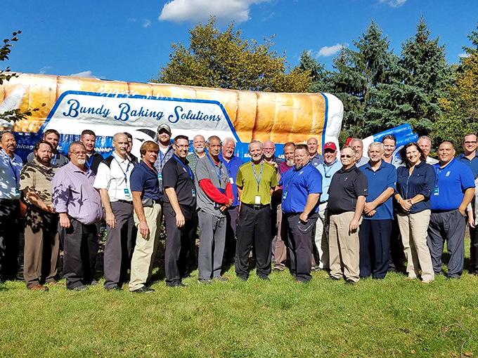 Our quarterly sales are on the rise! Company representatives gather to celebrate their unusual mascot, proving business and whimsy can coexist beautifully.