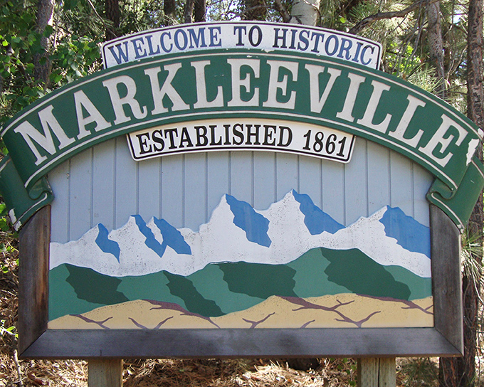 "Established 1861" declares the welcome sign, though the mountains behind it silently boast of being established millions of years earlier.
