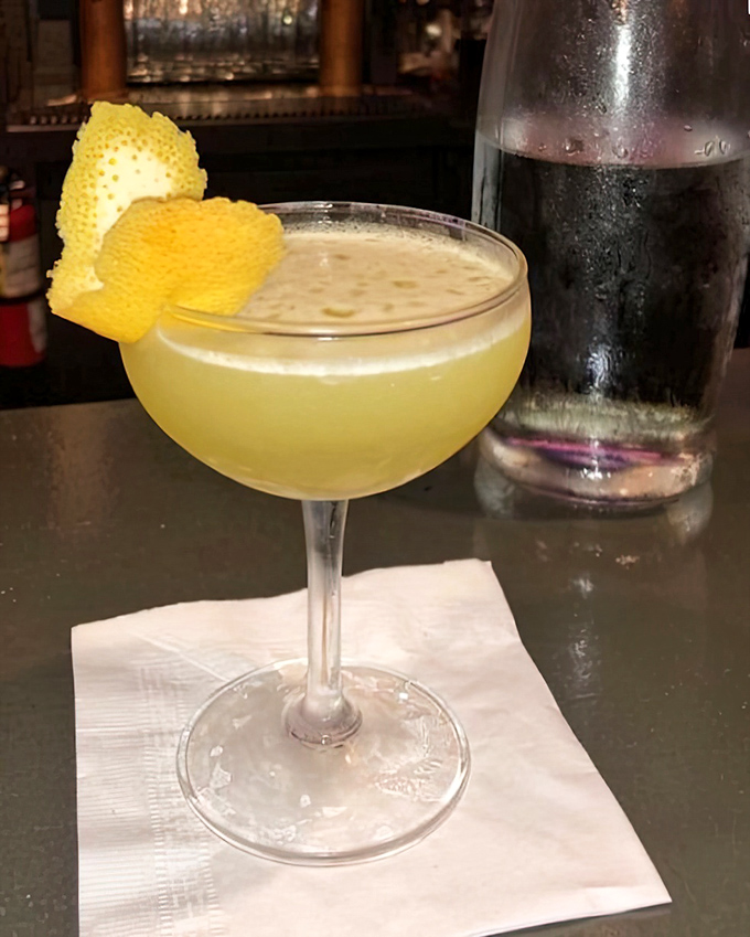 A cocktail that's dressed better than most people at formal events. That lemon twist is showing off, and I'm here for it.