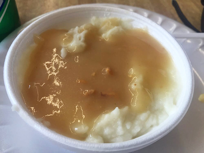 Mashed potatoes and gravy that remind you why comfort food earned its name &ndash; a warm, savory hug in a humble takeout container.