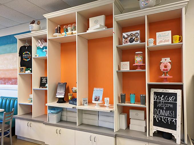 The merchandise wall with its bright orange backdrop showcases Donna's branded goodies. Because sometimes you need to take the donut spirit home with you.