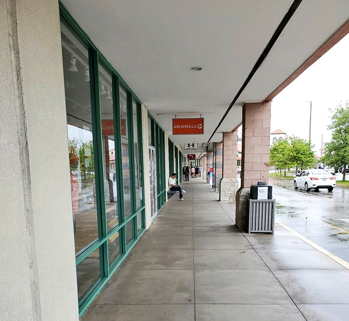 The covered walkway provides merciful shade for shoppers, turning potential heatstroke into merely productive perspiration.