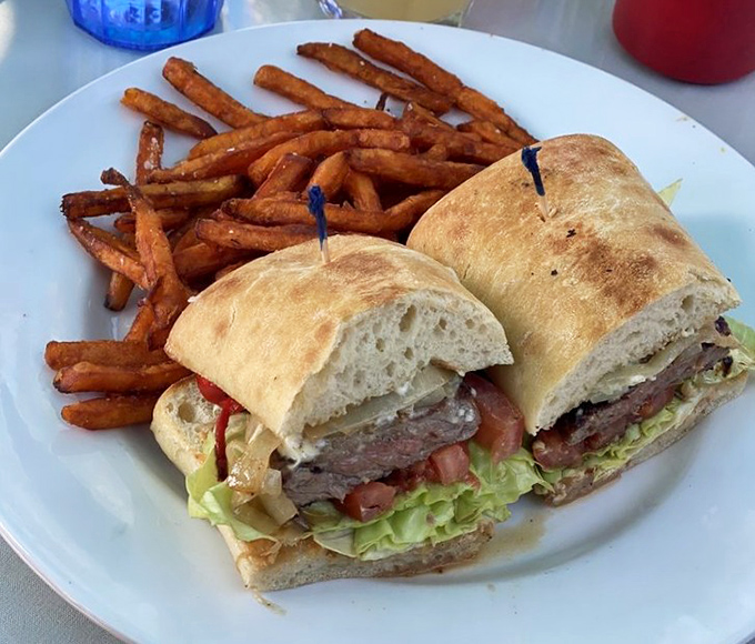 A sandwich so perfectly constructed it deserves architectural awards, with sweet potato fries that make regular fries question their life choices.