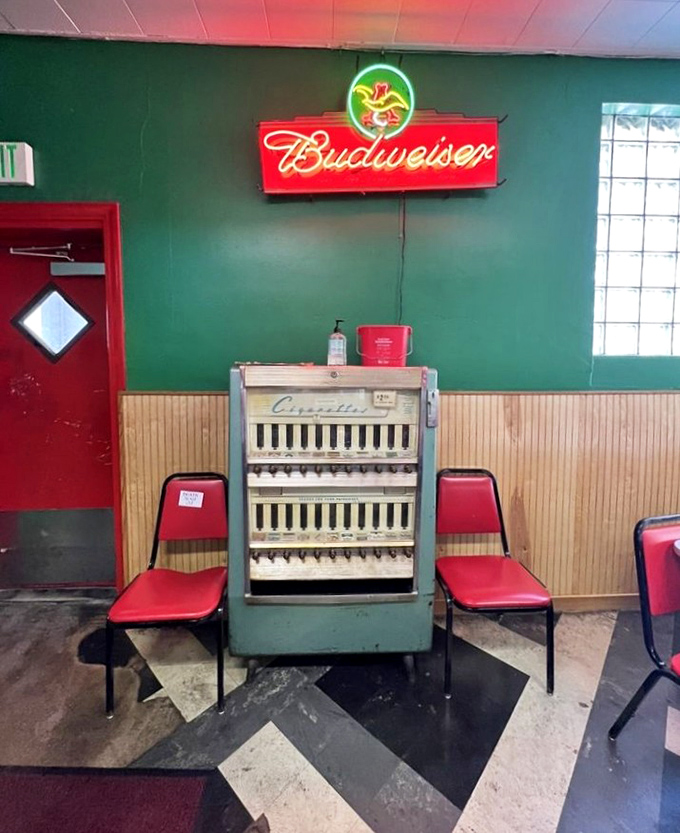 This vintage cigarette machine stands as a time capsule from an era when restaurants had smoking sections and burgers cost less than a dollar.