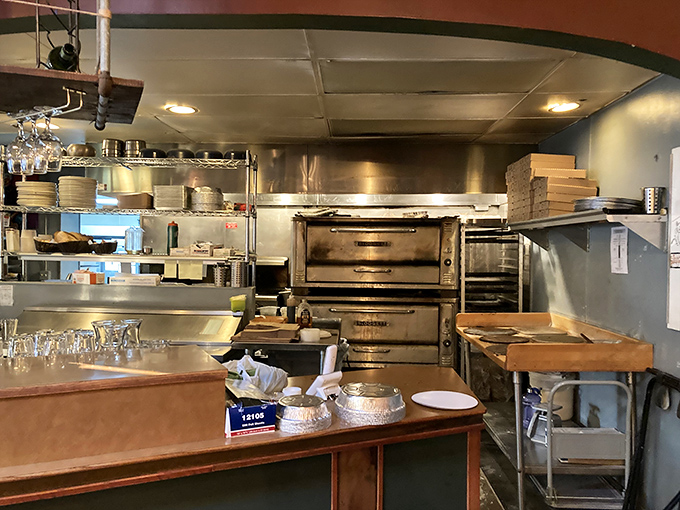 The open kitchen reveals the wizard behind the curtain—professional-grade ovens turning out the magic that keeps locals coming back.