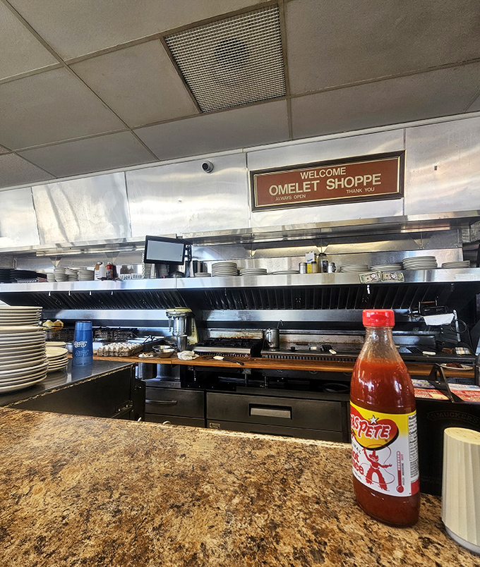 The open kitchen where breakfast dreams come true. That bottle of hot sauce standing guard is ready for those who think they can handle the heat.