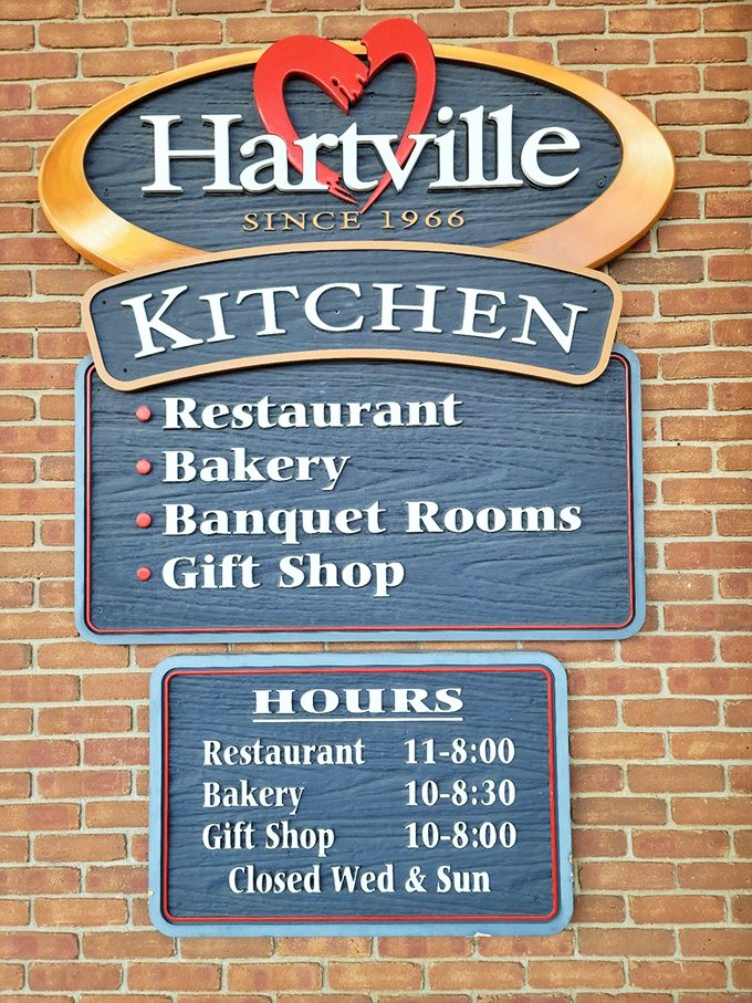 The sign reveals not just hours but a promise—behind these brick walls awaits a complete Hartville experience of food, gifts, and memories.