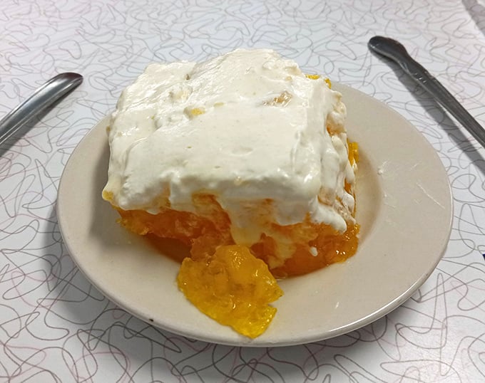 Orange creamsicle cake that tastes like summer vacation memories. That pool of sunshine-colored filling is making a break for freedom. 