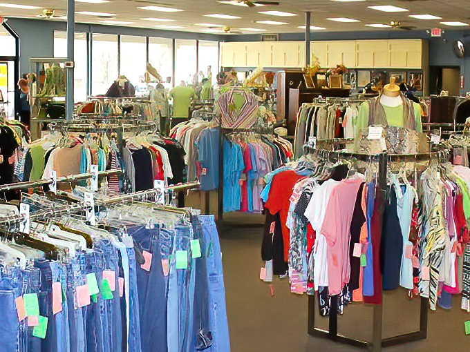 Denim dominates the foreground while color-coded racks create a rainbow road through the store. Organization is the unsung hero here.