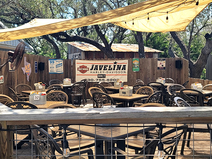The outdoor dining area, where shade trees and canvas covers create the perfect setting for post-burger bliss and cold Texas beer.