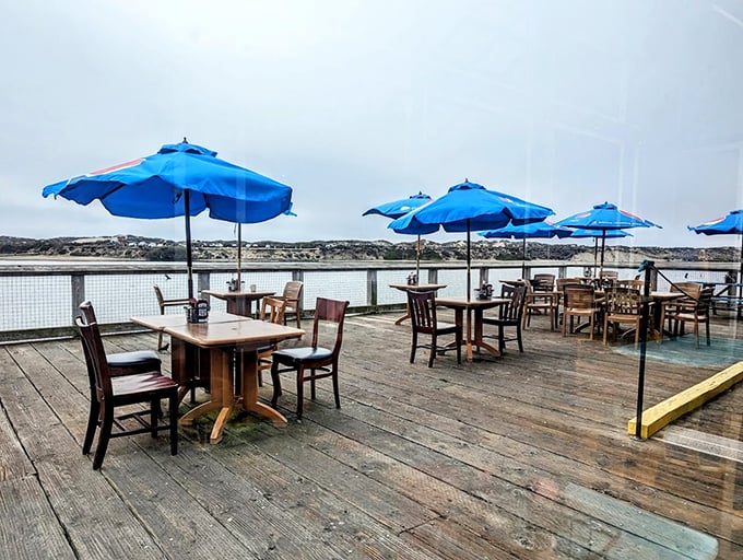 The outdoor deck where blue umbrellas mirror the sky and harbor waters. Even on foggy days, there's something magical about dining with the ocean as your backdrop.