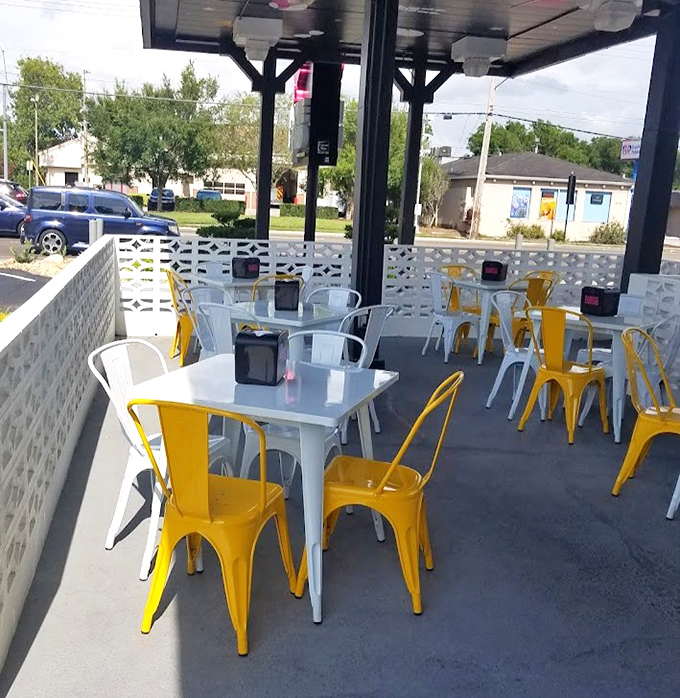 Yellow and white metal chairs dot the outdoor patio &ndash; a cheerful spot to recover from flavor overload while plotting your next chicken adventure. 