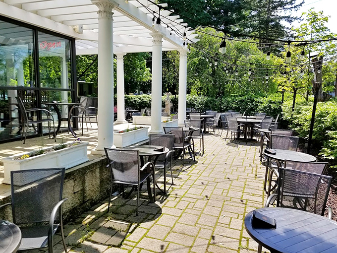 Al fresco dining with Grecian charm. The pergola-covered patio offers a Mediterranean escape complete with string lights and gentle breezes.