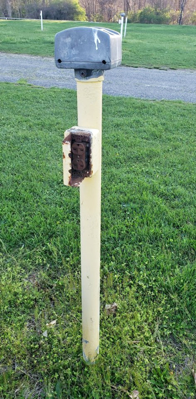 A vintage speaker pole stands as a charming relic, though most viewers now tune their car radios for crystal-clear sound.