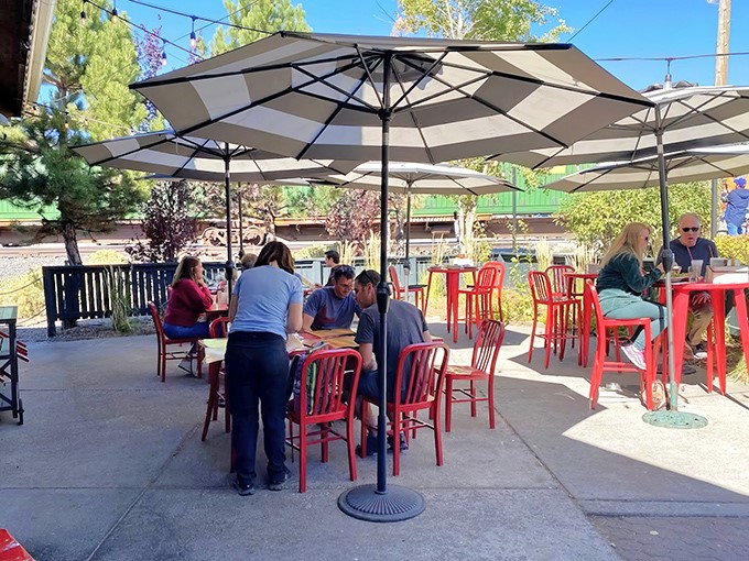 Red chairs pop against the outdoor patio, where mountain air seasons every bite with a dash of Sierra Nevada freshness.
