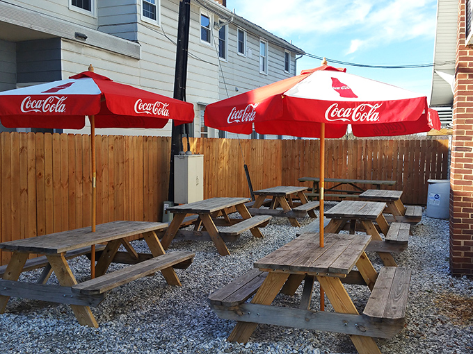 The outdoor seating area&mdash;where picnic tables become thrones and every bite tastes better under those Coca-Cola umbrellas.