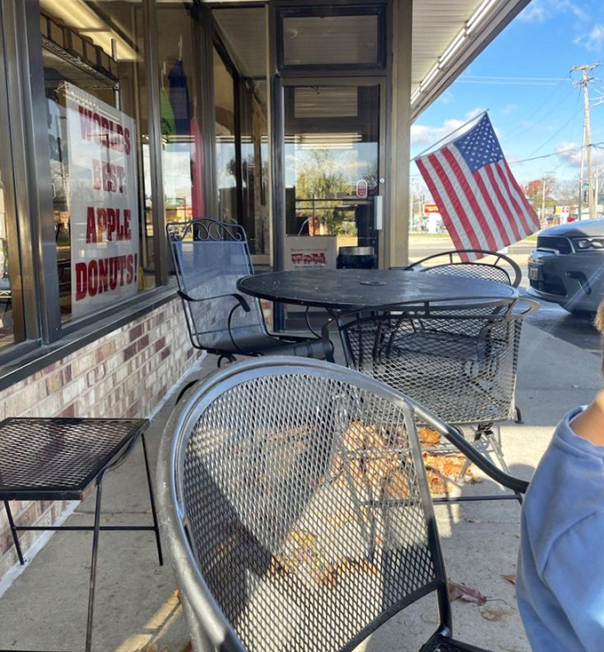 Outdoor seating with a side of Americana. Nothing says "local institution" quite like metal chairs, brick walls, and a proudly displayed flag.