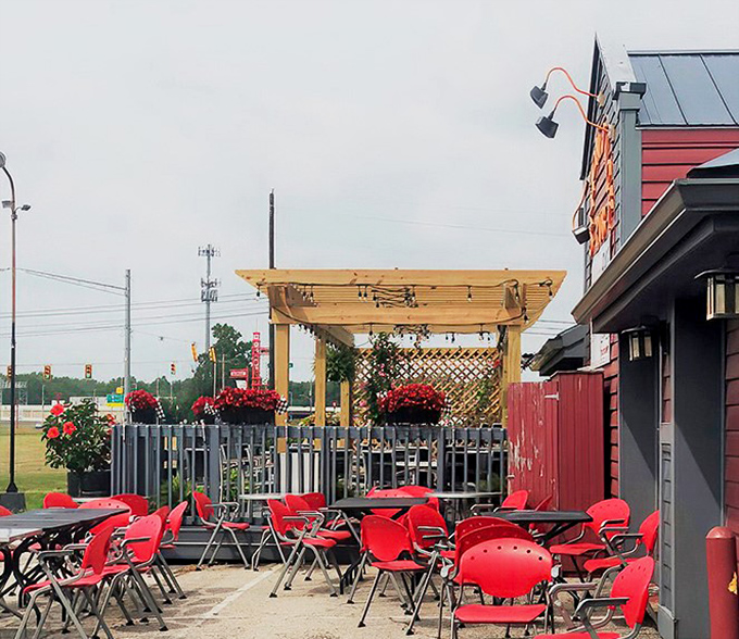 Red chairs and outdoor seating prove that British pub culture adapts beautifully to Indiana summers.