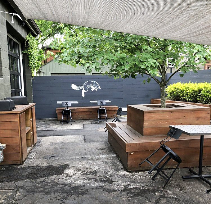 The outdoor sanctuary you didn't know you needed. Wooden benches and planters create a peaceful urban oasis for enjoying your caffeine and sugar rush.